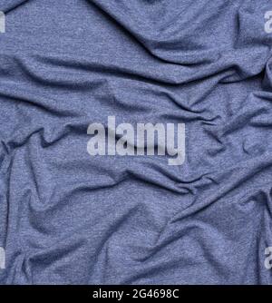 wrinkled blue cotton fabric for sewing t-shirts and clothing, close up ...