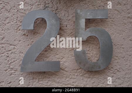 House number "25" attached to a wall Stock Photo - Alamy