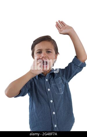 Cute boy shouting against white background Stock Photo - Alamy