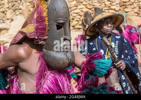 Dogon dancers performing the Dama ritual dance wearing Kanaga masks ...