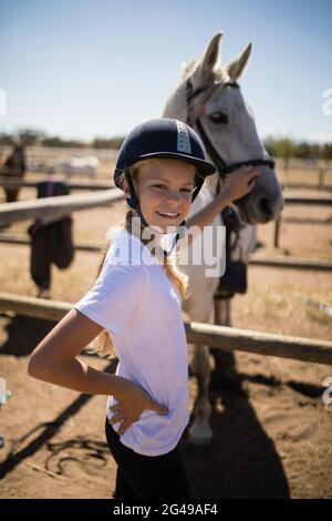 Girl caressing the white horse in the ranch Stock Photo - Alamy