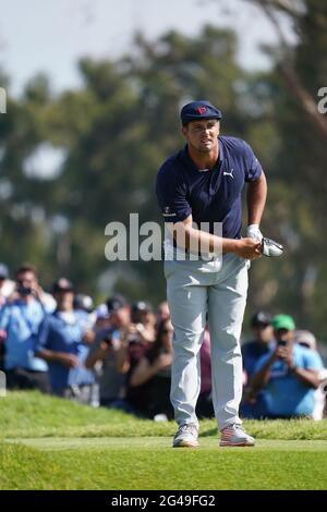 Bryson DeChambeau watches his tee shot on the eighth hole during the ...