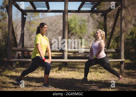 Women exercising during obstacle course in boot camp Stock Photo - Alamy