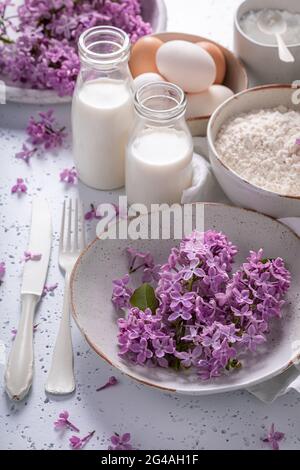 Sweet fried lilac flower with powdered sugar. Summer dessert. Lilac ...