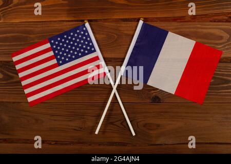 Flag of France and flag of USA crossed with each other on a white ...