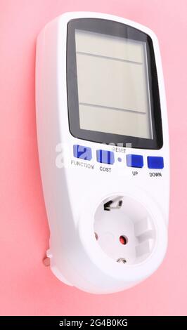Digital Power Meter on pink background Stock Photo - Alamy