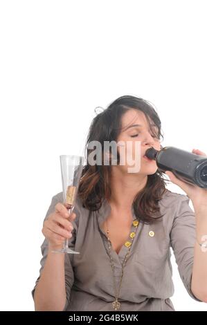 young woman prefers drinking her red wine straight out of the bottle ...