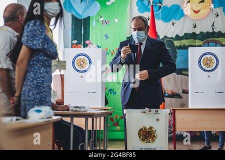 Yerevan, Armenia. 20th June, 2021. A voter casts her vote at a polling ...