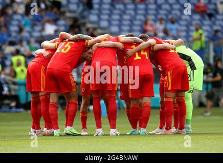 Wales players huddle together on the pitch ahead of the FIFA World Cup ...