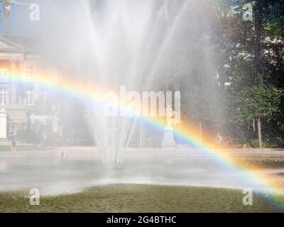 Artificial fountain with reflected bubble water rainbow in natural park ...