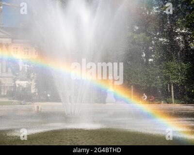 Artificial fountain with reflected bubble water rainbow in natural park ...
