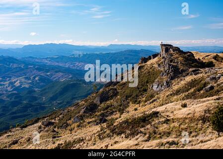Hiker overlooking Mohaka valley from Bell rock formation, Hawke's Bay ...