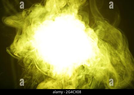 Artificial yellow light illuminates smoke on dark background Stock ...