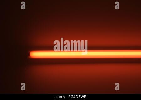 Orange LED bar on a wall Stock Photo - Alamy