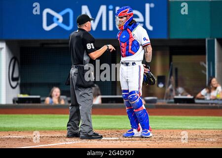 Texas Rangers catcher Jose Trevino flips the ball to the pitcher ...