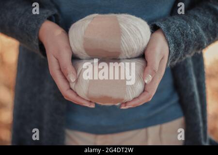 Person hands hold nature wool alpaca yarn balls with blank labels Stock ...