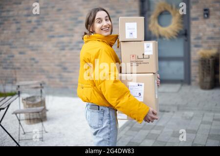 Woman coming home with parcels Stock Photo - Alamy