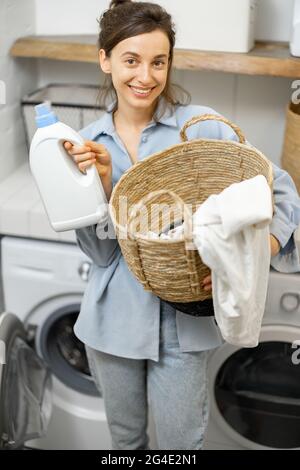 happy housewife woman in laundry room with washing machine Stock Photo ...