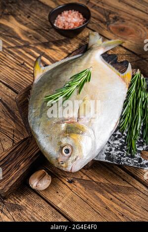 Raw fish Sunfish or pompano on a wooden board. wooden background. Top ...