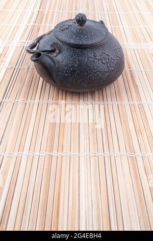 Black asian cast iron kettle and tea with flower petals in vintage ...