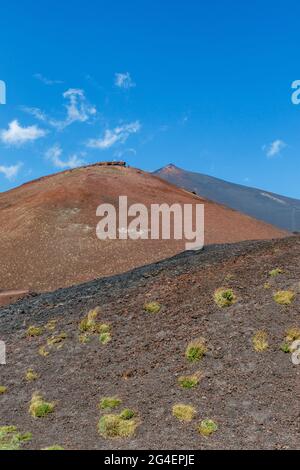 Scenic view of famous Mount Etna covered with clouds and smoke during ...