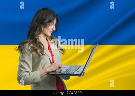 Freelance in Ukraine. Beautiful young woman freelancer uses laptop ...