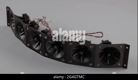A set of six tweeters or speakers attached to a metal front plate. Each ...