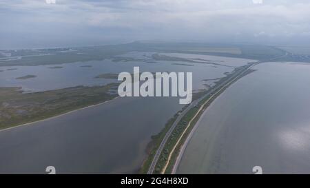 A highway that runs along a narrow spit between the sea and the estuary ...
