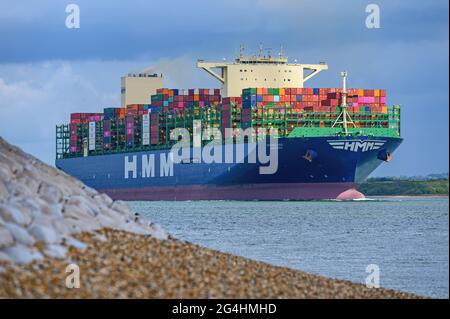 A large ONE container ship and an HMM cargo ship navigate Qingdao Port ...