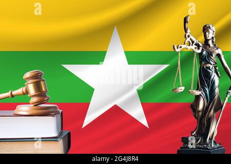 Myanmar flag with statue of lady justice and judicial scales in dark ...