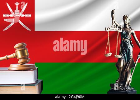 Oman flag with statue of lady justice, constitution and judge hammer on ...