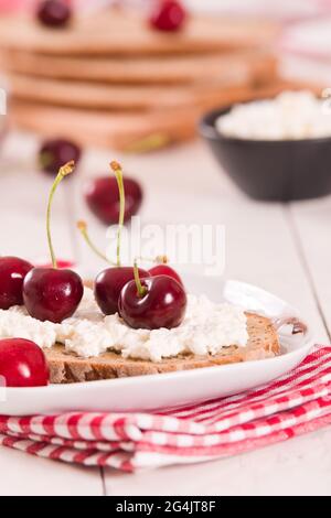 Rye bread with cottage cheese and cherries Stock Photo - Alamy