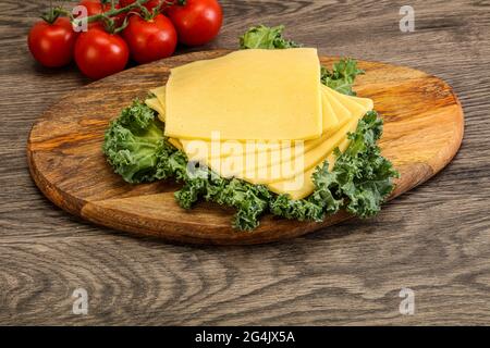 Sliced Gauda cheese snack over board Stock Photo - Alamy