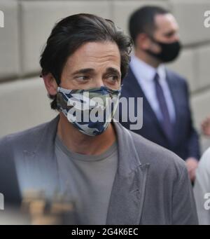 Actor Adrien Brody posing for photographers after Armani fashion show ...