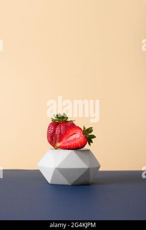 Fresh ugly strawberry on stand on a white background. Close up. Concept ...