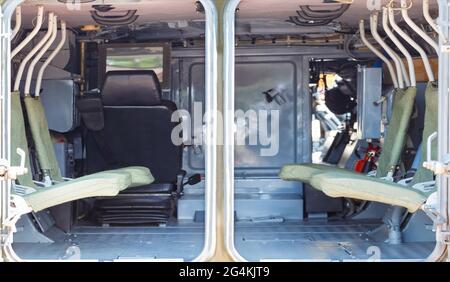 The interior of an armored infantry fighting vehicle with rows of seats ...