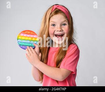 Happy funny girl holding rainbow umbrella. Cute Happy schoolgirl ...