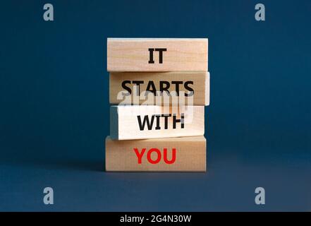 It starts with you symbol. Wooden blocks with words 'it starts with you ...