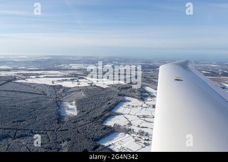 Aerial overview of the Belgian Ardennes during a winter flight with an ...