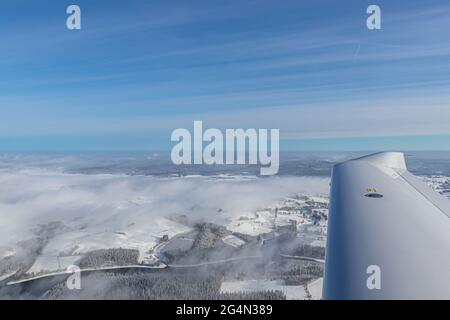 Aerial overview of the Belgian Ardennes during a winter flight with an ...