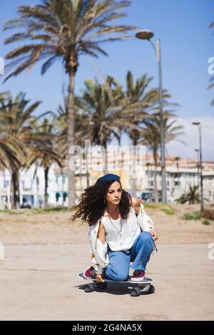 Happy young male radio host using microphone and headphones while ...