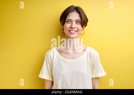 Portrait of optimistic minded woman dressed khaki overall finger on ...