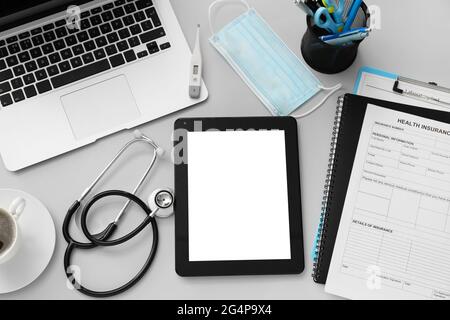 Tablet computer with stethoscope and accessories of doctor on color ...