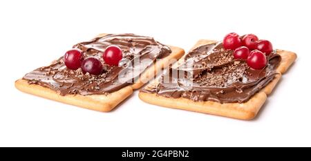 Tasty crackers with chocolate paste and cranberry on grey background ...