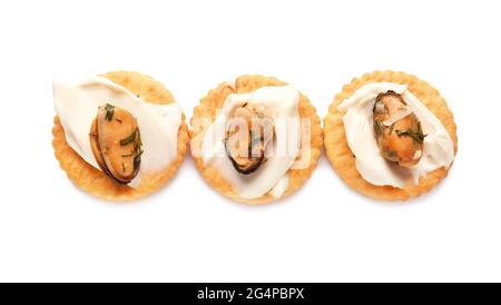 Tasty crackers with cheese and mussels on light wooden background ...