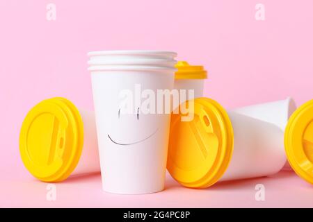 Takeaway cups for coffee with drawn smile on color background Stock ...