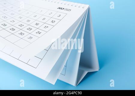 Flip calendar with page of July on color background, closeup Stock ...