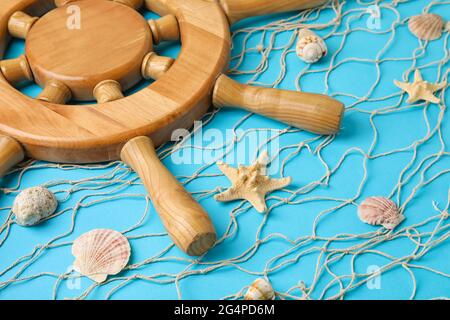 Helm, net and sea shells on wooden background Stock Photo - Alamy