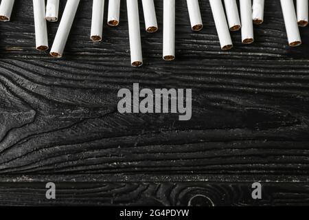 Cigarettes on dark wooden background Stock Photo - Alamy