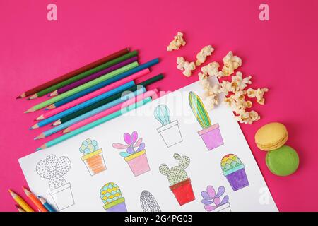 Composition with coloring picture, pencils and popcorn on color wooden ...